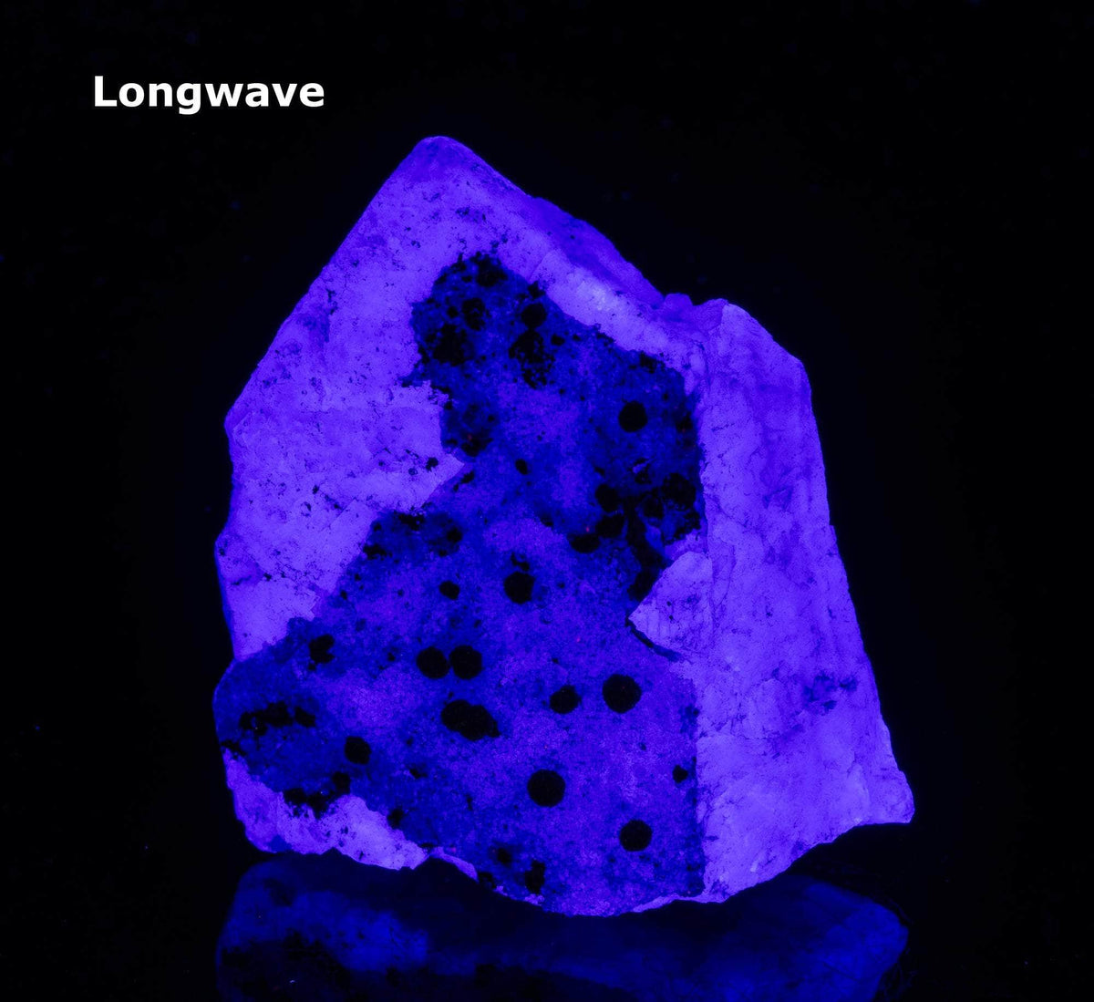 A nice piece of purple fluorite displaying a very bright blue ...